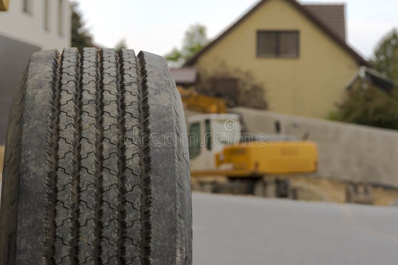 Construction Machine Wheel. in the Background a Construction Site and ...