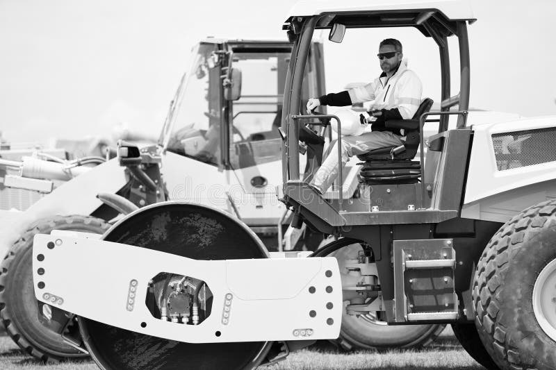 Construction Machinery Worker at Roller. Machinery in a Manufacturing ...