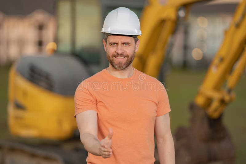 Construction Man with Excavator at Industrial Site. Worker in Helmet ...