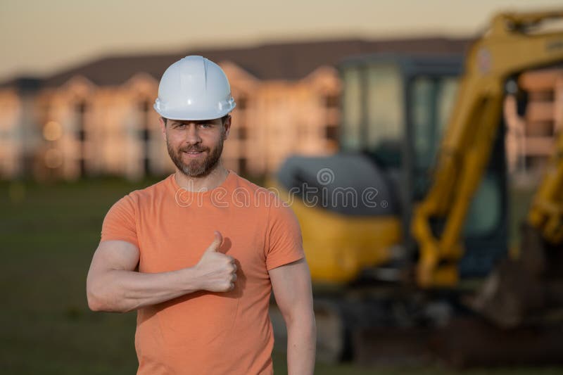 Construction Man with Excavator at Industrial Site. Worker in Helmet ...