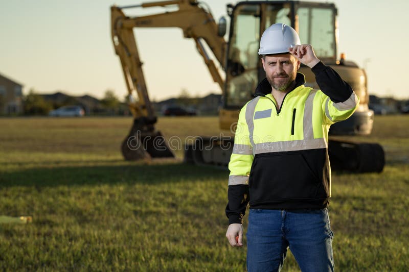 Construction Man Industry with Excavator at Industrial Site. Worker in ...