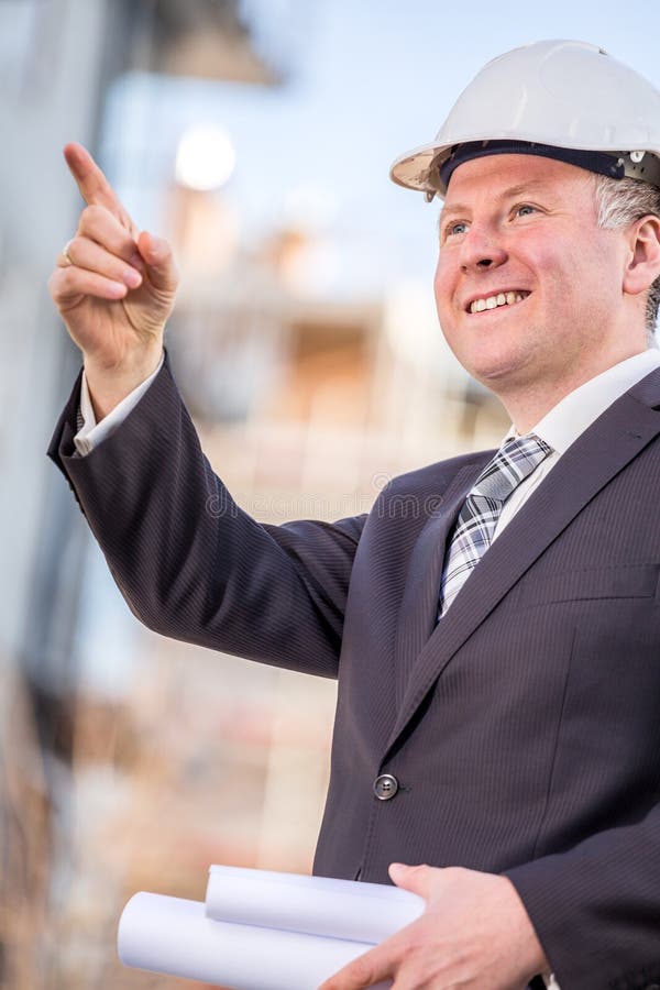 Construction Manager with Blueprints Stock Photo - Image of looking ...