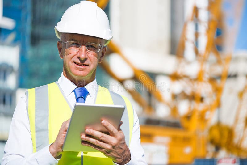 Construction Manager Controlling Building Site and Tablet Device in His ...