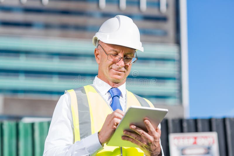 Construction Manager Controlling Building Site and Tablet Device in His ...