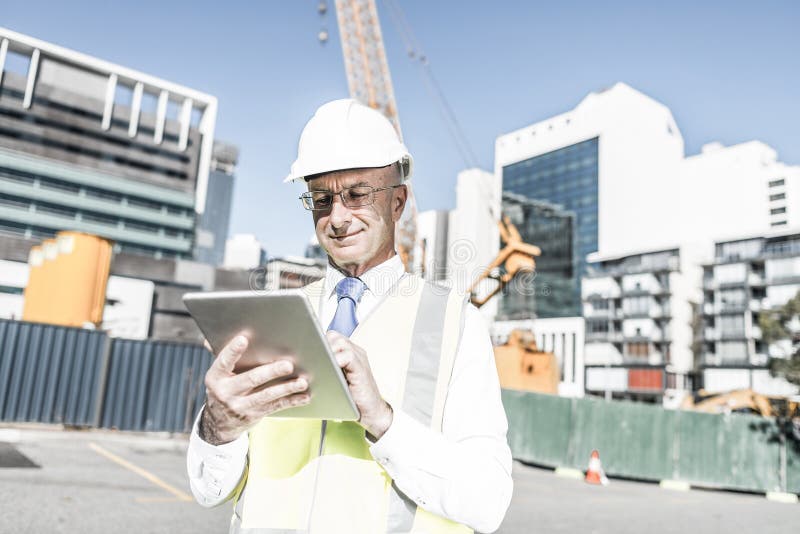 Construction Manager Controlling Building Site and Tablet Device Stock ...
