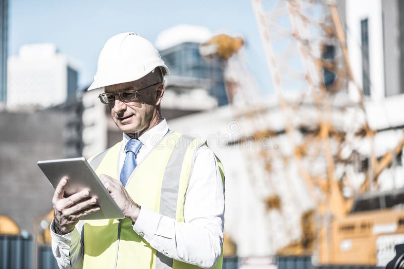 Construction Manager Controlling Building Site and Tablet Device Stock ...
