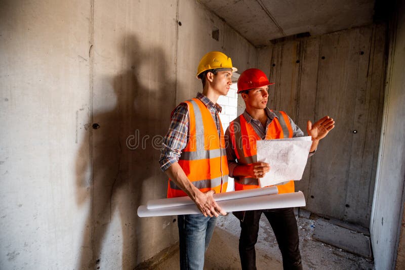 Construction Manager and Engineer Dressed in Orange Work Vests and ...