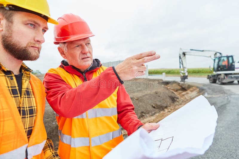 Construction Manager and Foreman with Construction Drawing on ...