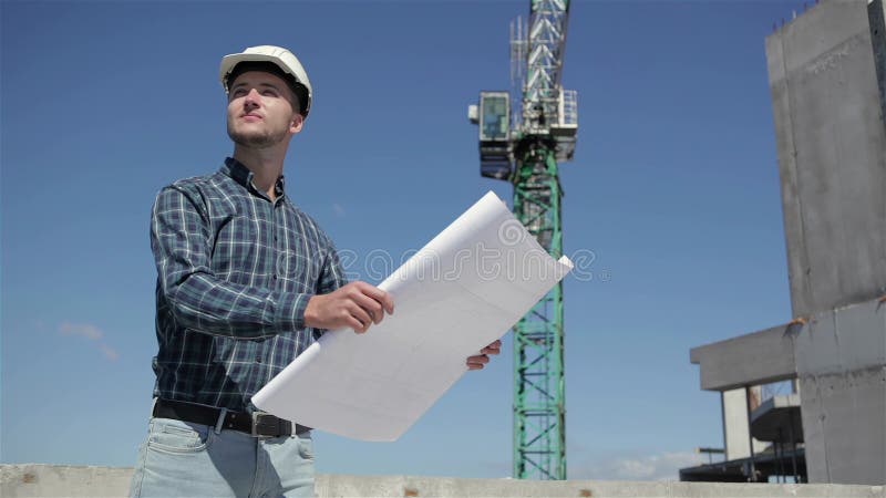 Construction Manager Look at the Sheet with Plan of Building Under ...