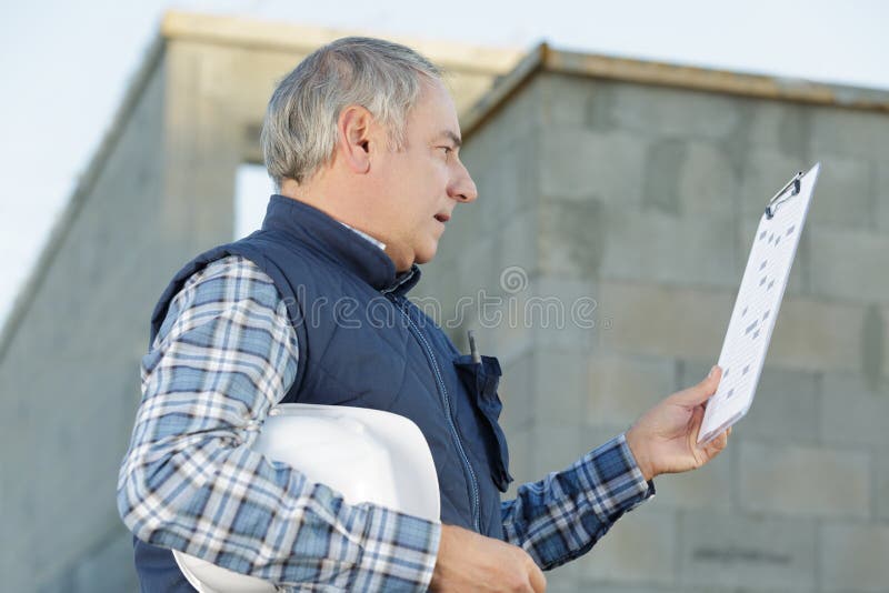 Construction Manager Reading Clipboards Stock Image - Image of notepad ...