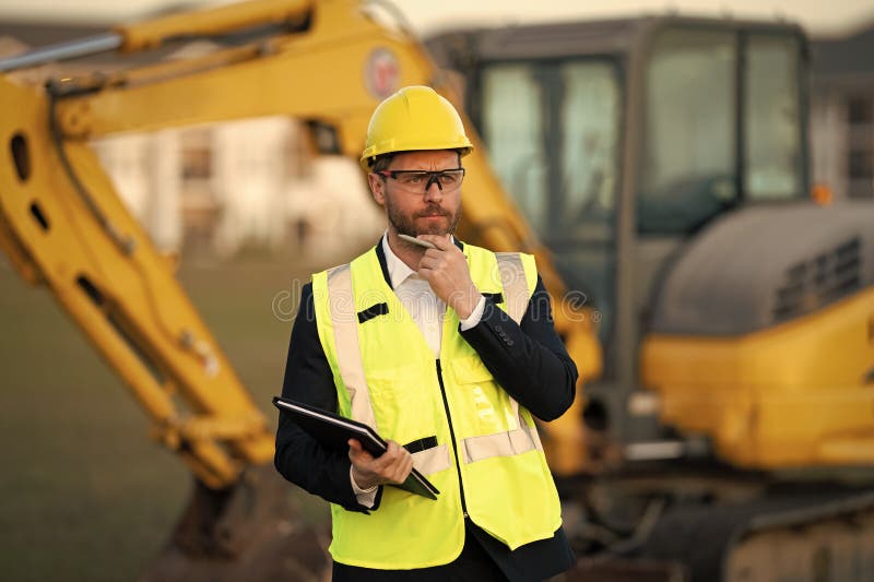Construction Manager in Suit and Helmet at a Construction Site ...