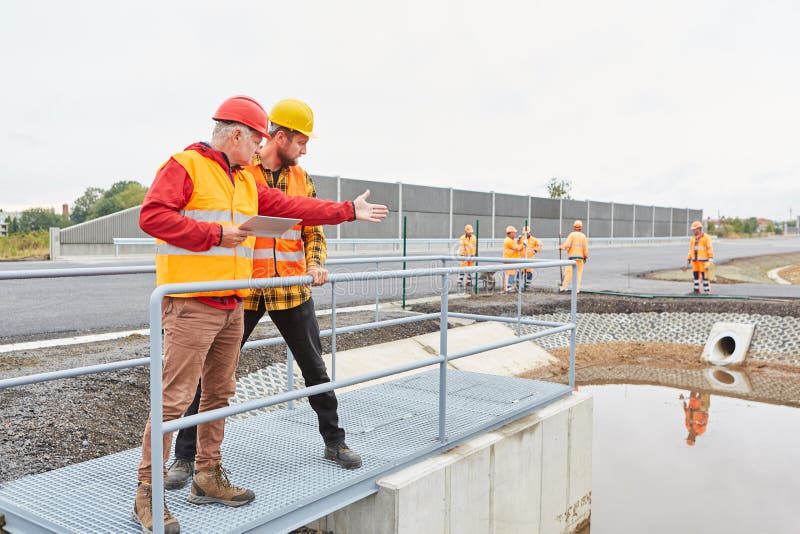 Construction Manager and Construction Workers during Inspection on ...