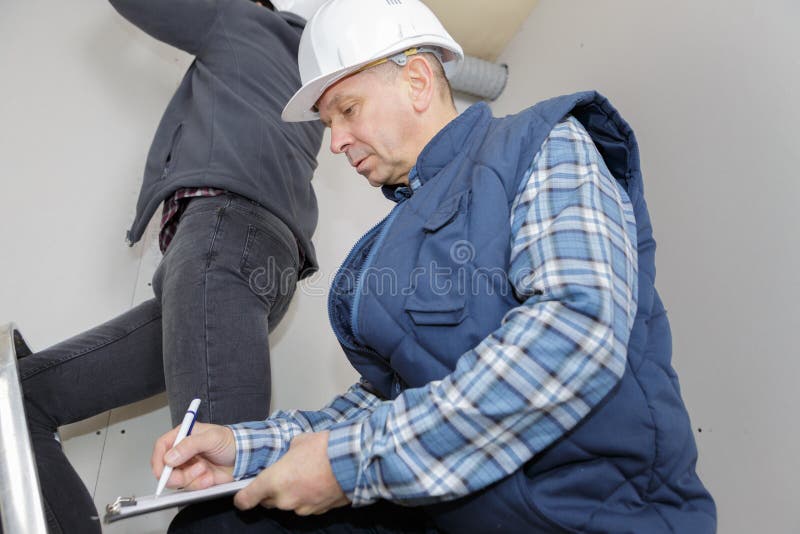 Construction Manager Writing on Clipboard Stock Image - Image of rate ...