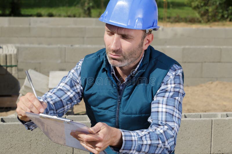 Construction Manager Writing Report at Construction Site Stock Photo ...