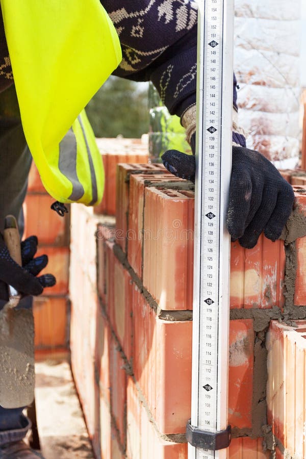 Construction Mason Worker Measures the Thickness of the Seams on the ...