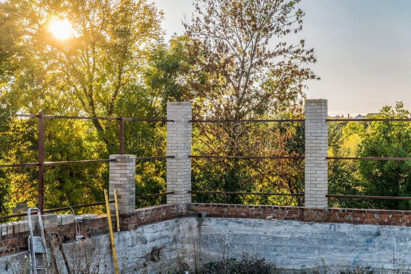Construction of a Metal Frame Fence with Brick Posts Stock Photo ...
