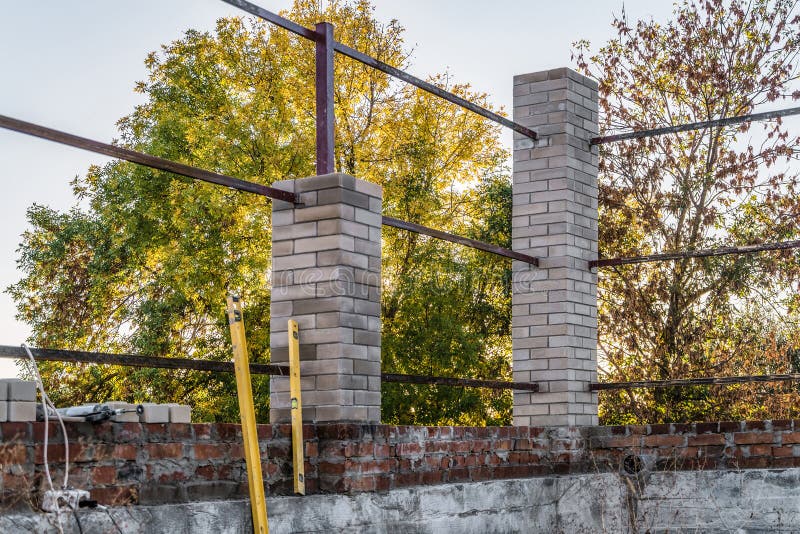 Construction of a Metal Frame Fence with Brick Posts Stock Photo ...