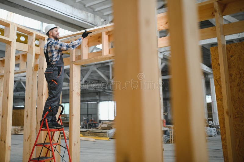 Construction of Modular Houses. a Carpenter or Builder Builds a Wooden House Stock Photo - Image ...