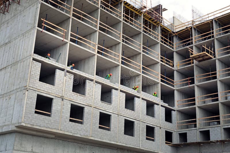 Construction of a Monolithic-frame Apartment Building, a Team of Masons ...