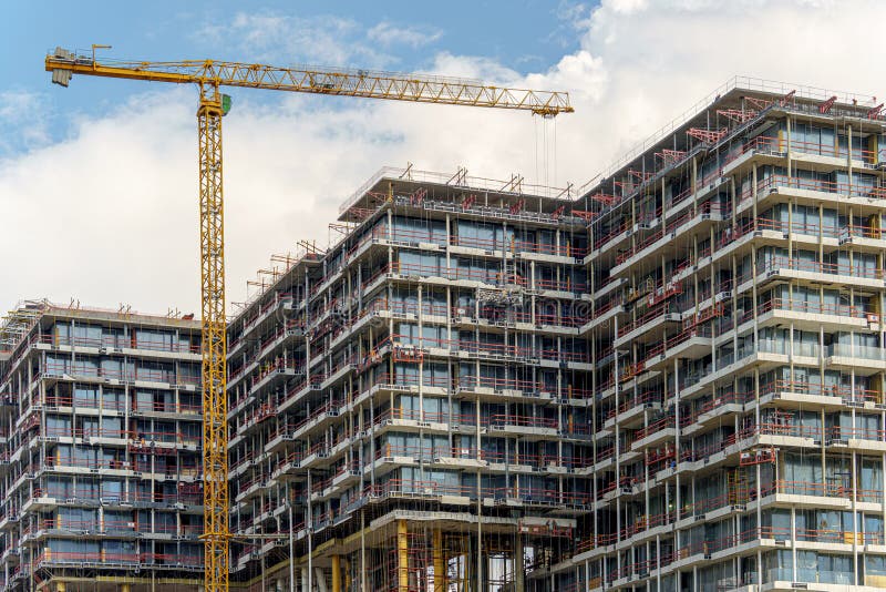 Construction of a Multi-unit Residential Building is Underway with the Help of a Tower Crane ...