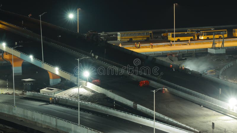Construction of New Highway is Underway in Night Time. Workers Install ...