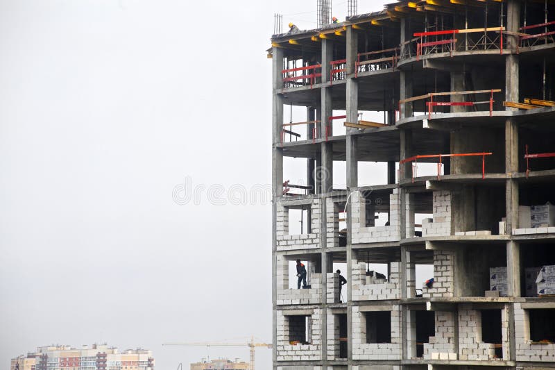 Construction of a New House with a Builders, in Background of Gray Sky ...