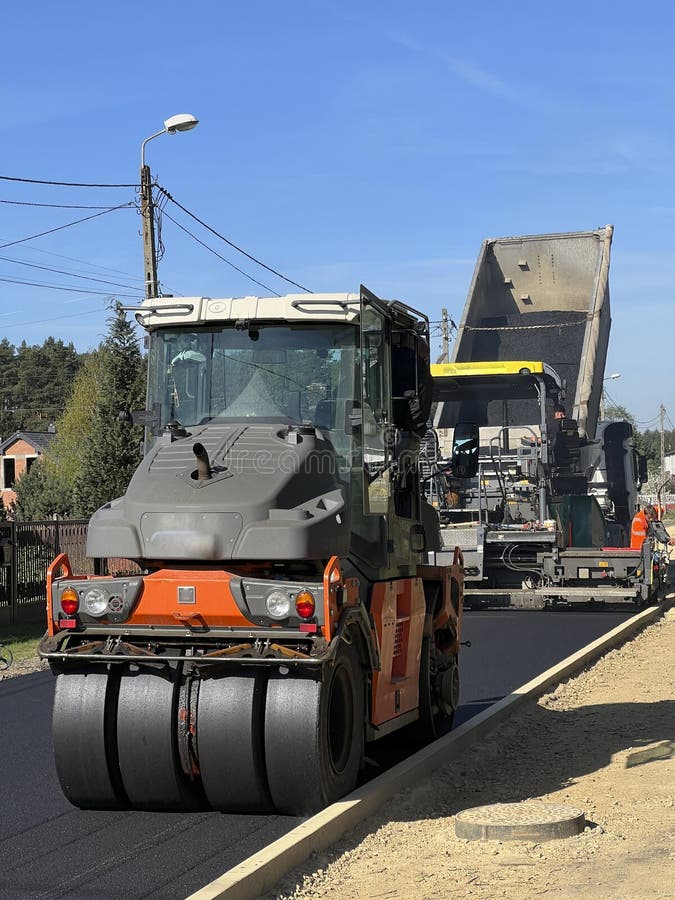 Construction of a New Street Surface. Laying a Layer of Asphalt with a ...