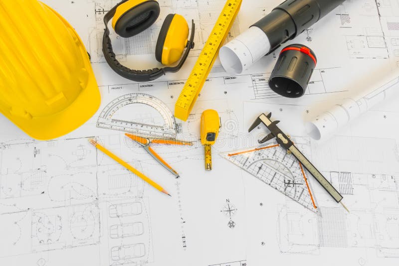 Construction Plans with Yellow Helmet and Drawing Tools on Blueprints ...