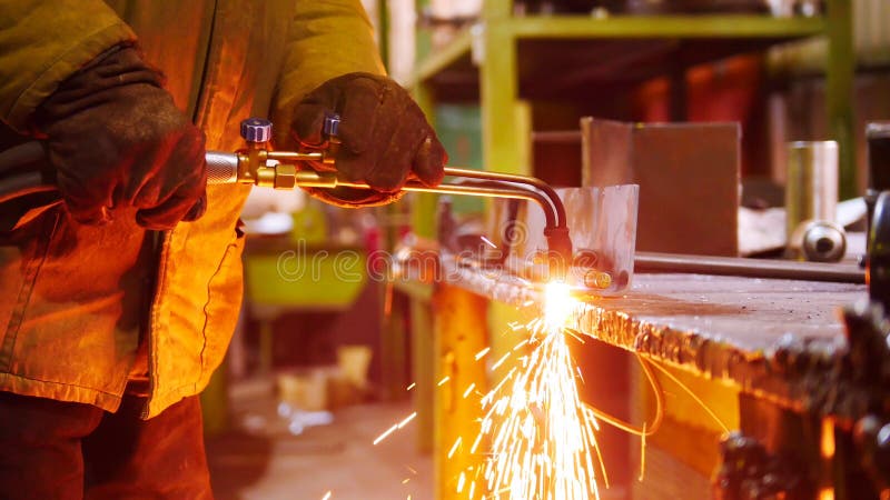 Construction Plant. a Man at His Workplace Using a Welding Machine ...