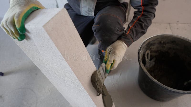 Construction Worker Applying Cement on Aerated Concrete Brick Stock ...
