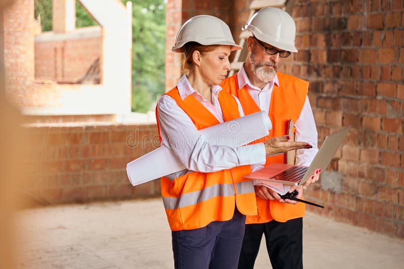 Construction Professionals Analyzing Data on Computer in Uncompleted ...