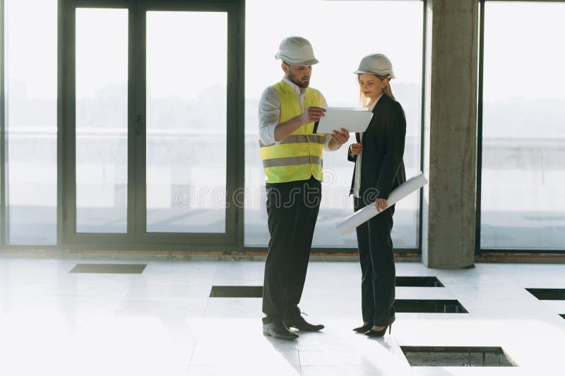 Construction Professionals Collaborate on Project Plans in Modern ...