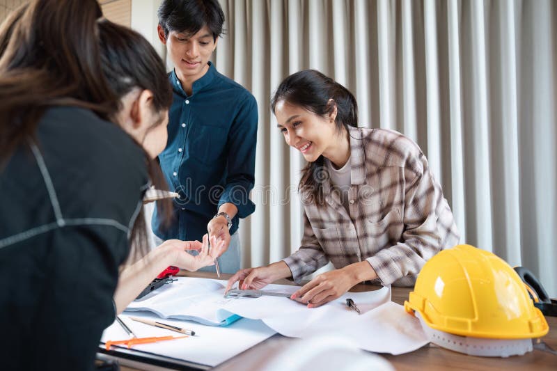 Construction Professionals Collaborating Over Blueprints and Project ...