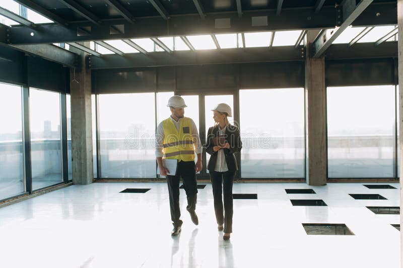 Construction Professionals Discussing Project Progress in Modern Office ...