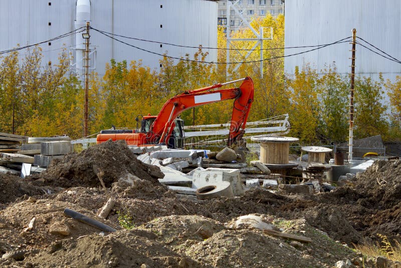 Construction: Red Excavator in the Middle of a Large Construction Site ...