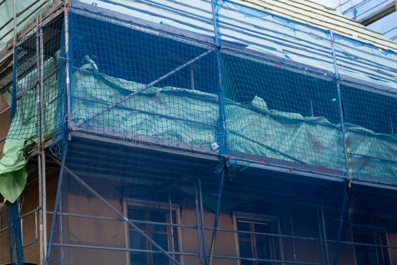 Construction and Repair of the House.Scaffolding in a Protective Blue ...