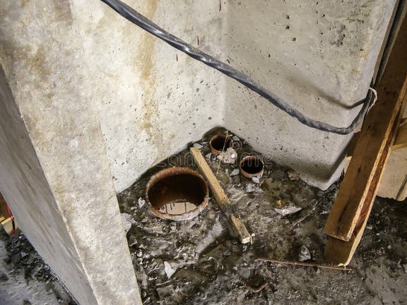 Close-up View of a Construction Site Corner Featuring Concrete, Pipes ...