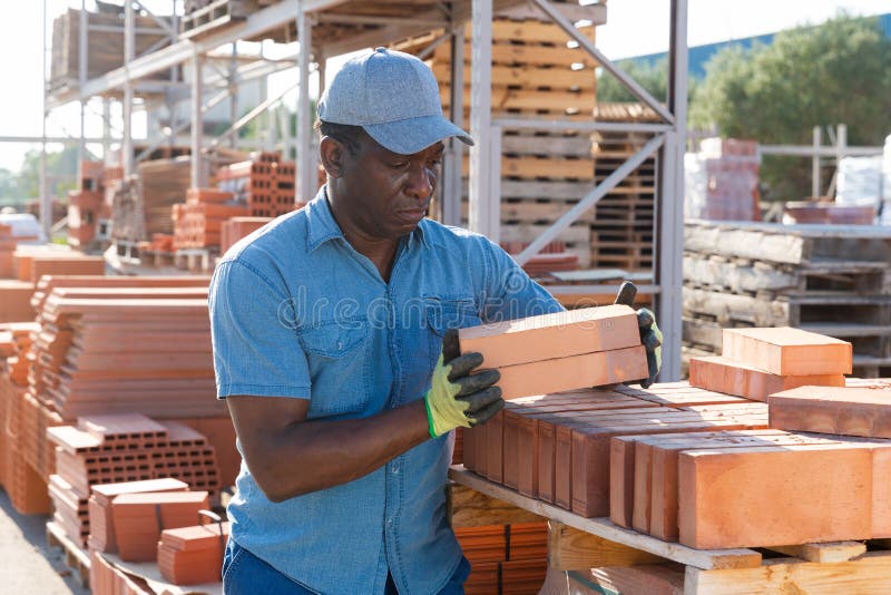 Construction Shop Worker Stacks Bricks on an Open Air Site at Summer ...