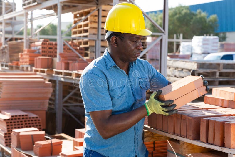 Construction Shop Worker Stacks Bricks on an Open Air Site at Summer ...