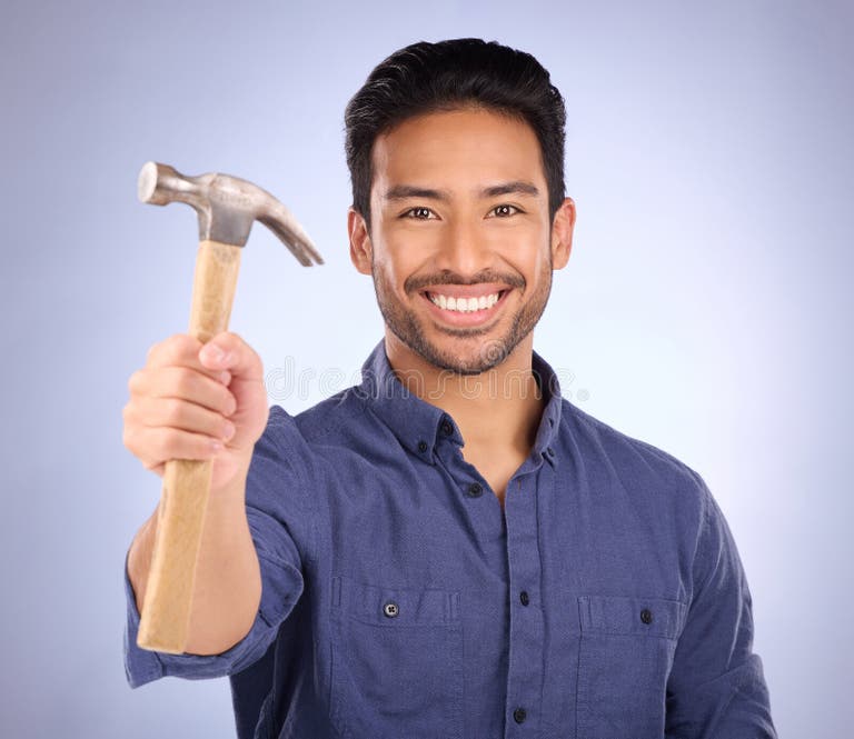 Construction, Showing and Portrait of an Asian Man with a Hammer Isolated on a Studio Background ...