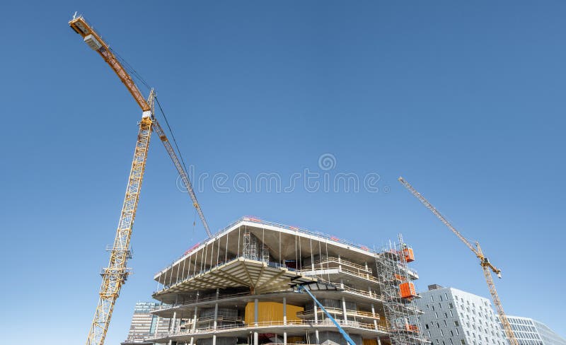 Construction Site of Building with Cranes and Derrick in the City Stock ...