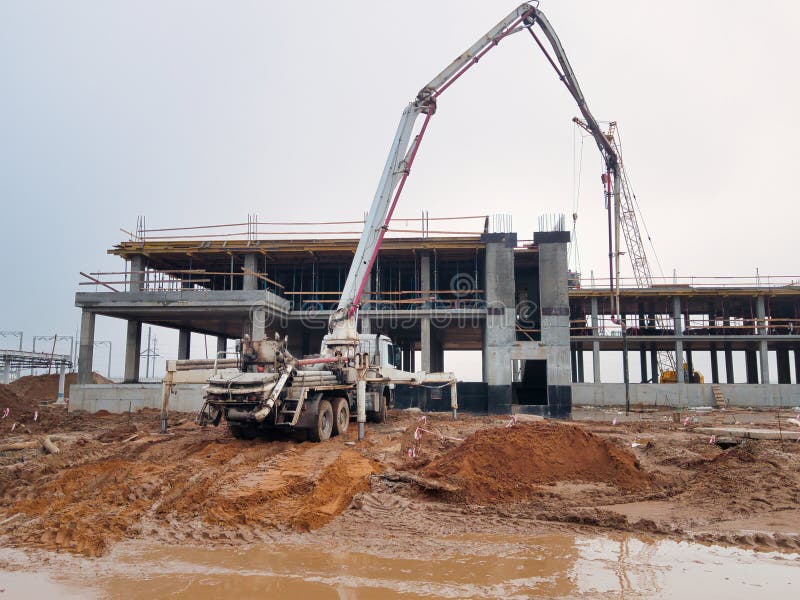 Construction Site Bustling with Activity As Concrete is Poured for a ...