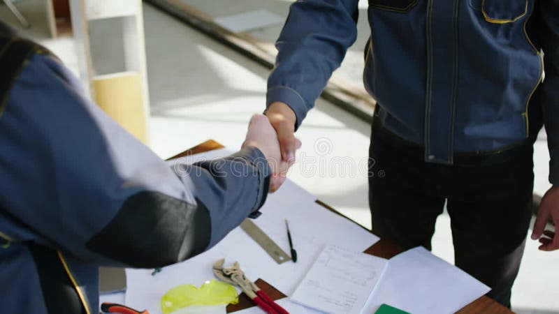 At Construction Site Closeup Taking Video of a Two Man Shaking Hands ...