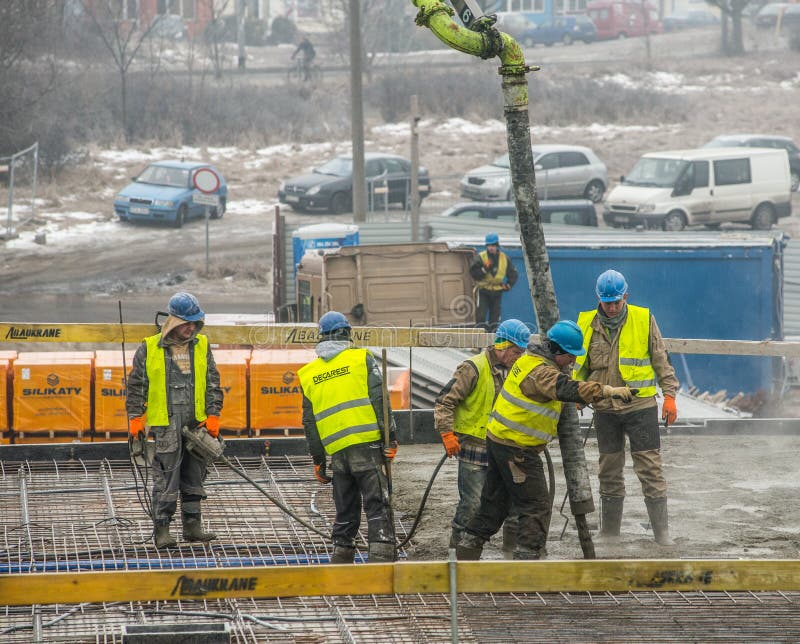 Construction Site with Concrete Pumping Works. a Group of Five Workers ...