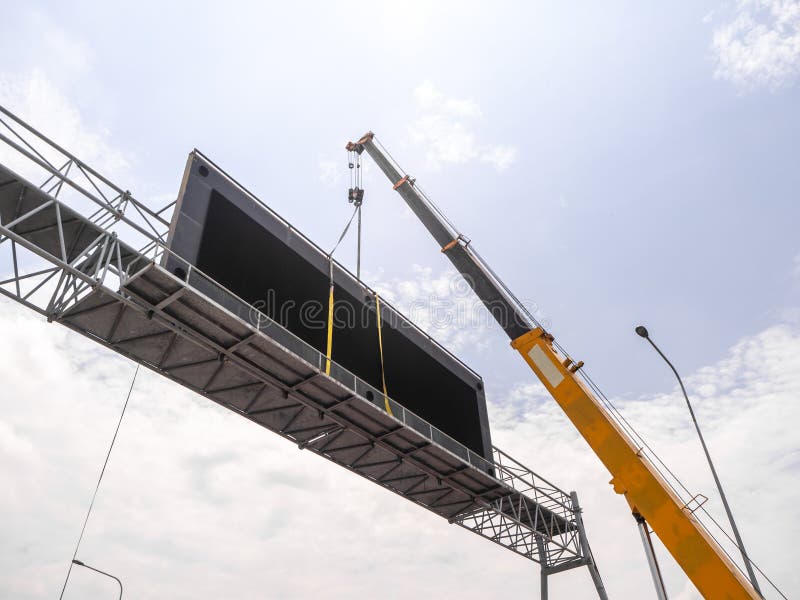 Construction Site Crane is Lifting a Led Signboard for Advertisement ...