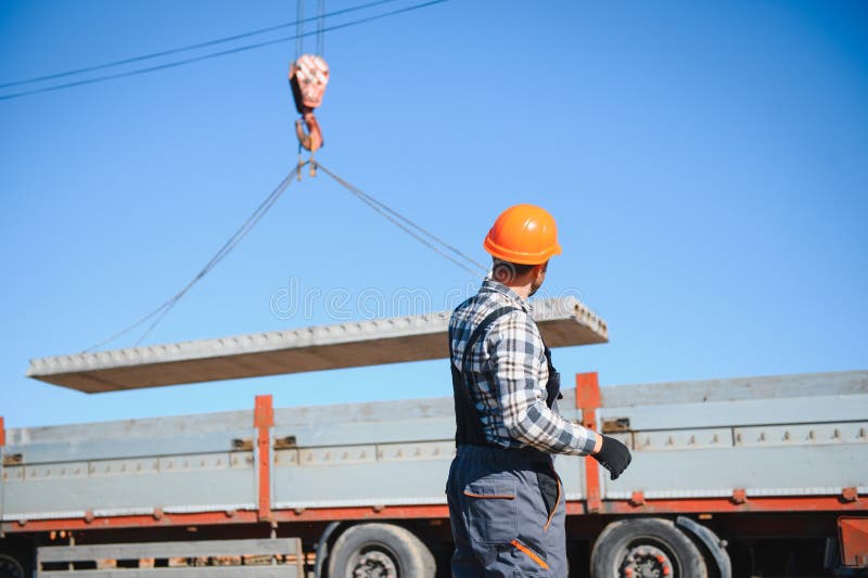 Construction Site Crane is Lifting a Precast Concrete Wall Panel To ...