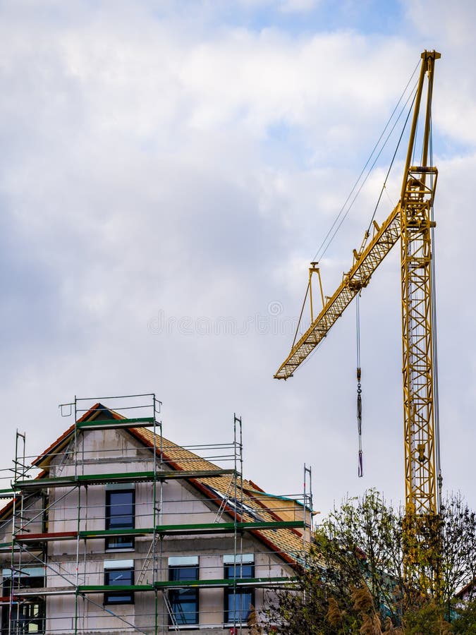 Construction Site with Crane and Scaffolding Around House Stock Image ...