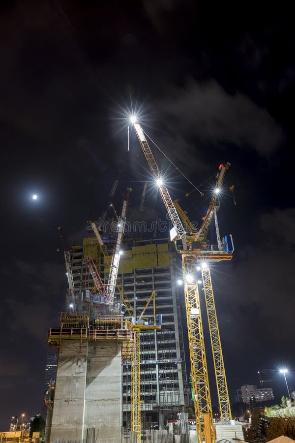 Construction Site with Cranes at Night Low Angle Vertical Stock Image ...