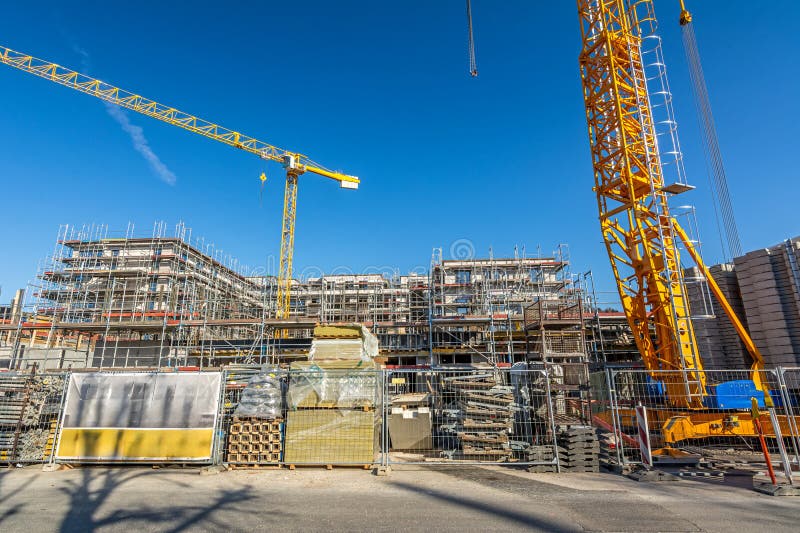 Construction Site with Cranes, Scaffolding, Fence and Unfinished ...