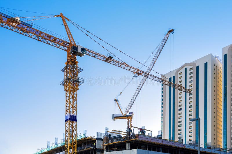 Construction Site with Cranes, Workers and Modern Buildings Editorial ...